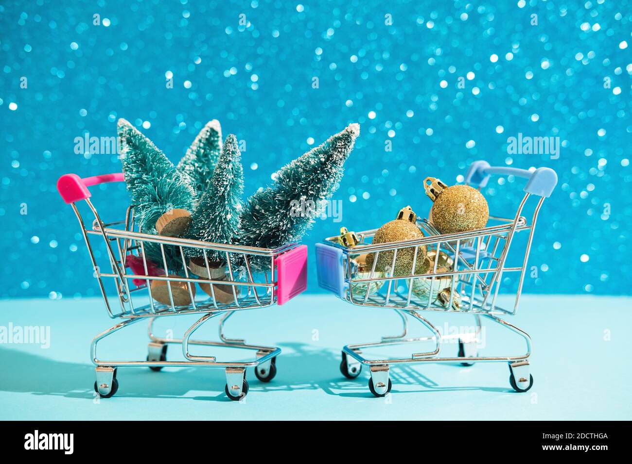 Minimal festive background with toy trees and Christmas golden balls in ...