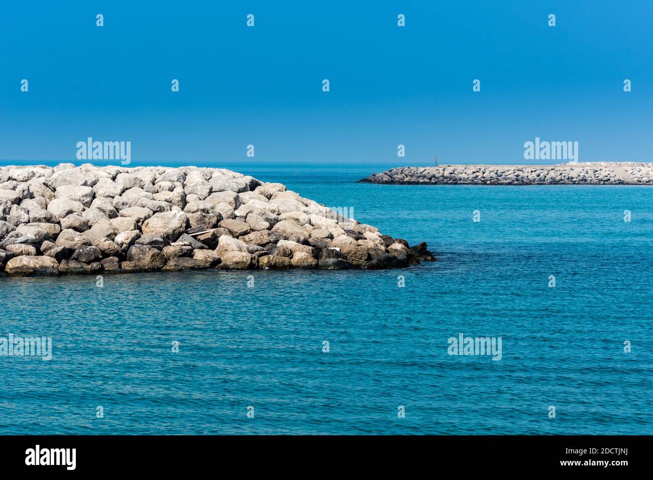 Blue sea and stone dam in the Persian Gulf in the Corniche park in the ...