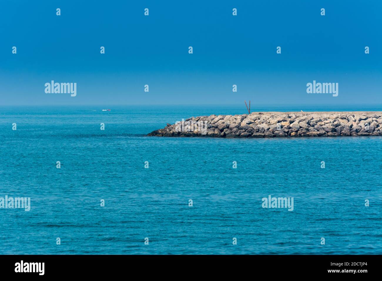 Blue sea and stone dam in the Persian Gulf in the Corniche park in the ...