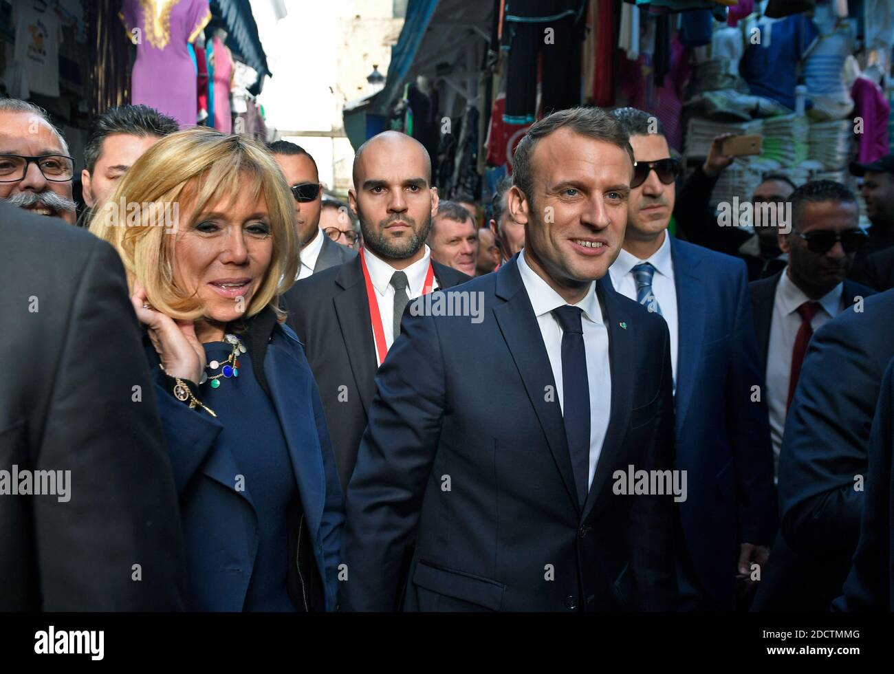 French President Emmanuel Macron (C-R) and his wife Brigitte (C-L) walk ...