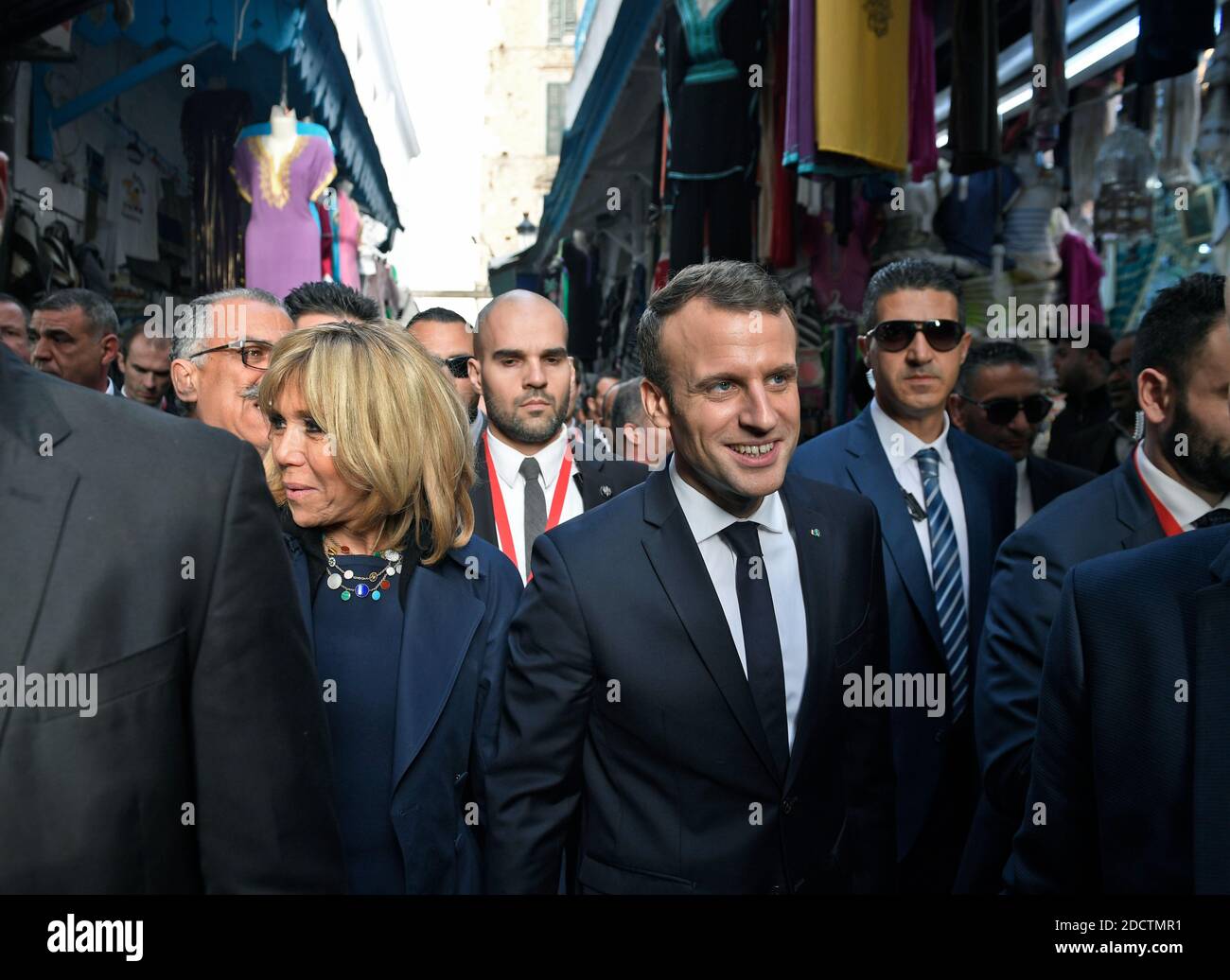 French President Emmanuel Macron (C-R) and his wife Brigitte (C-L) walk ...