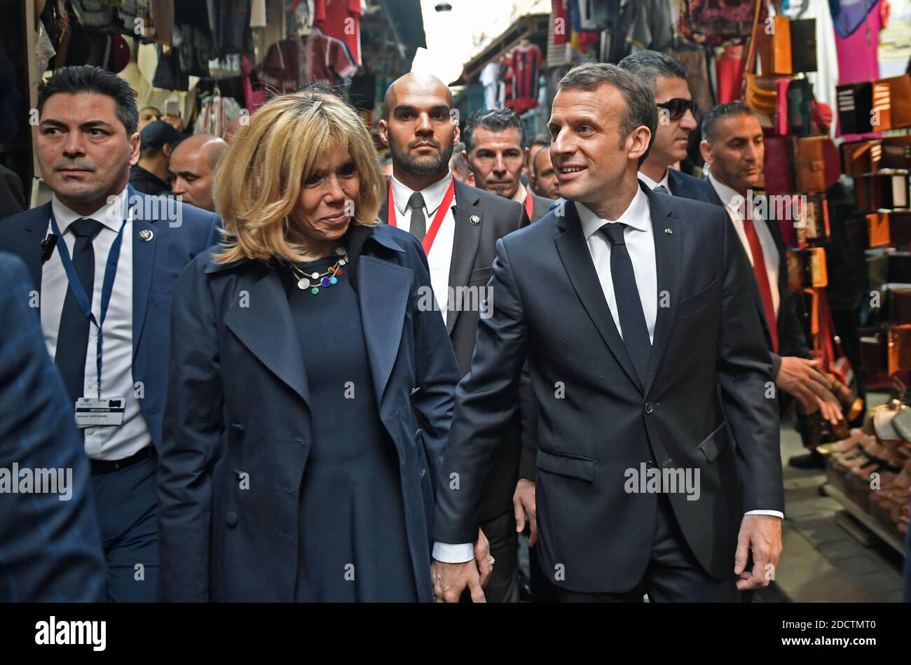 French President Emmanuel Macron (C-R) and his wife Brigitte (C-L) walk ...