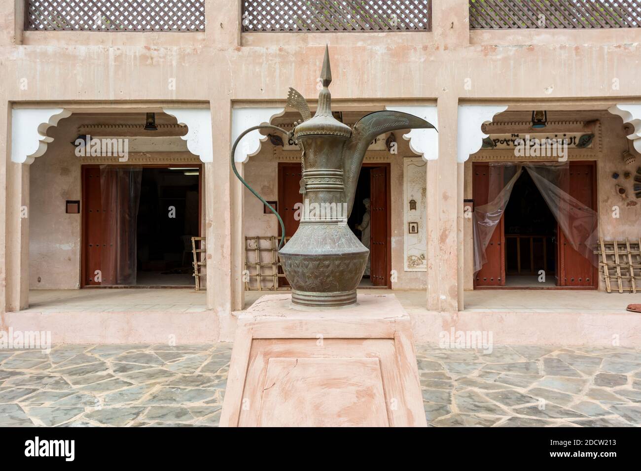 A traditional Arabian copper teapot statue with background of souvenir ...