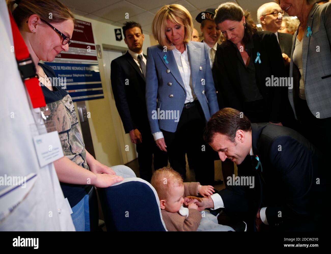 French President Emmanuel Macron talks to a baby as his wife Brigitte ...