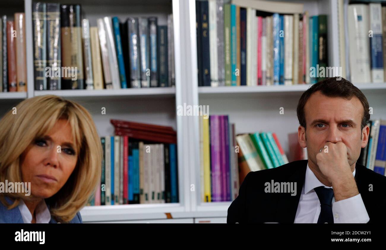 French President Emmanuel Macron and his wife Brigitte listen to ...