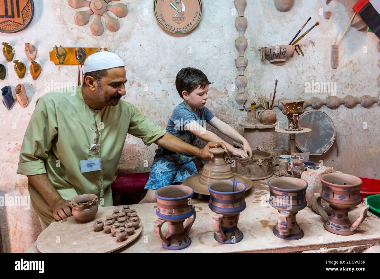 An Islamic potter teaching a boy making ceramic pots in Heritage ...