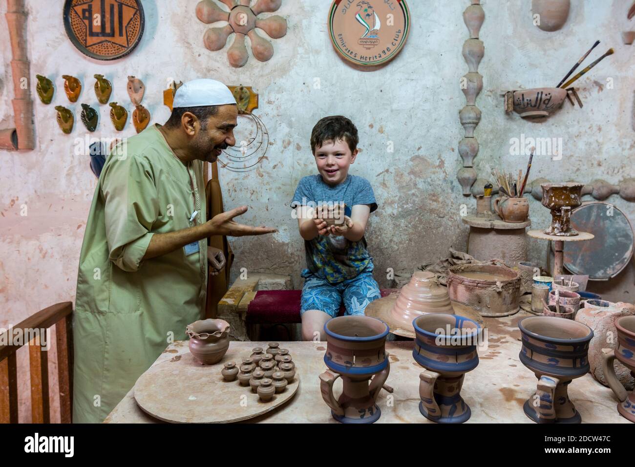An Islamic potter teaching a boy making ceramic pots in Heritage ...