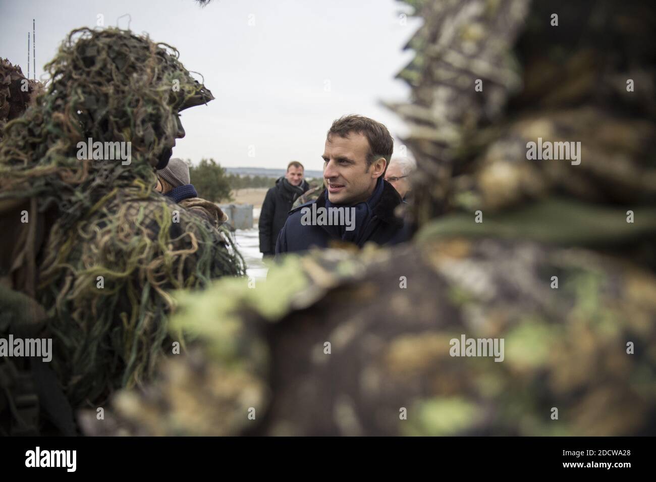 French President Emmanuel Macron (R) speaks with soldiers as he attends ...