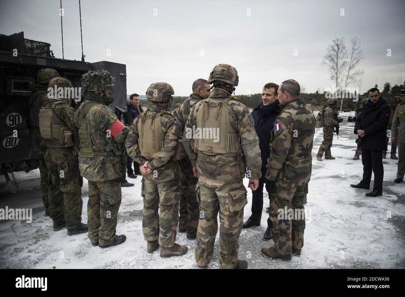 French President Emmanuel Macron (R) speaks with soldiers as he attends ...