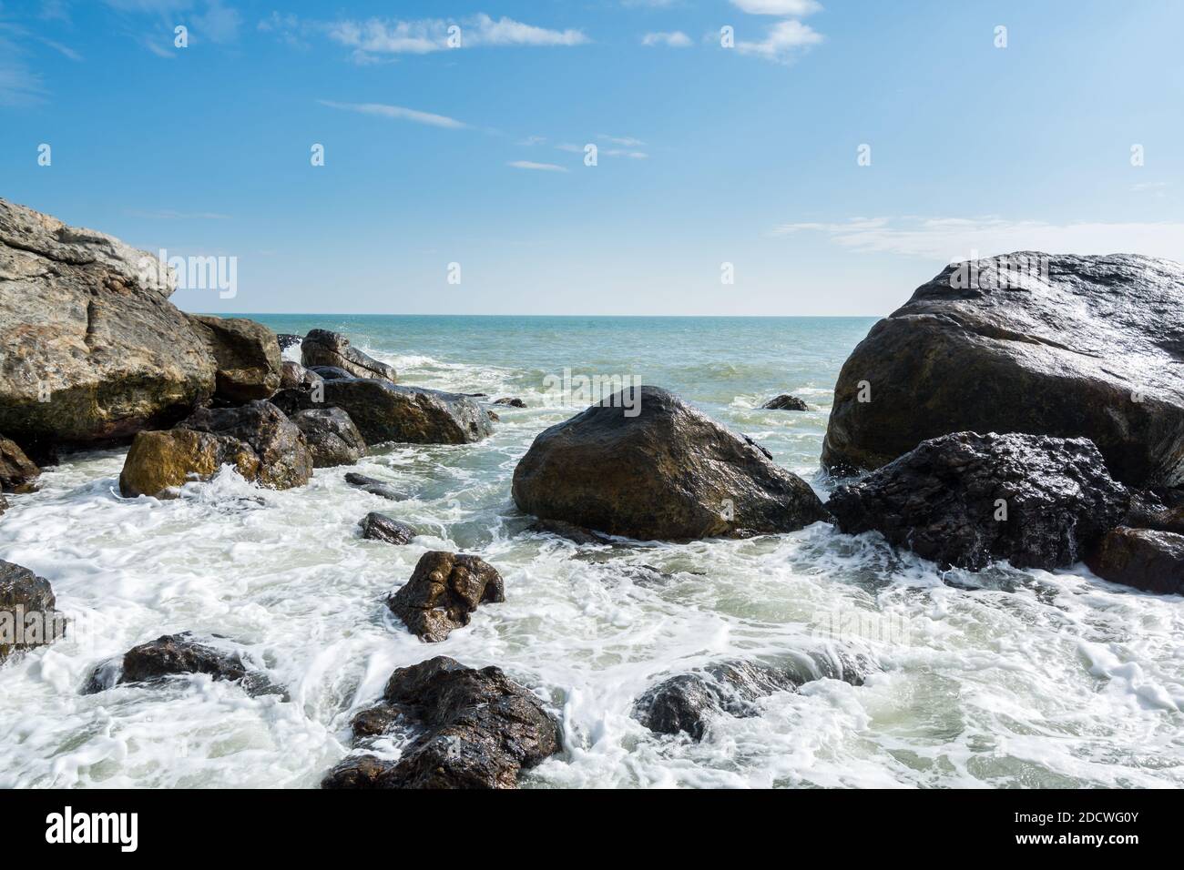 Seascape of waves splashing the stones in the rocky coastline of Yangxi ...