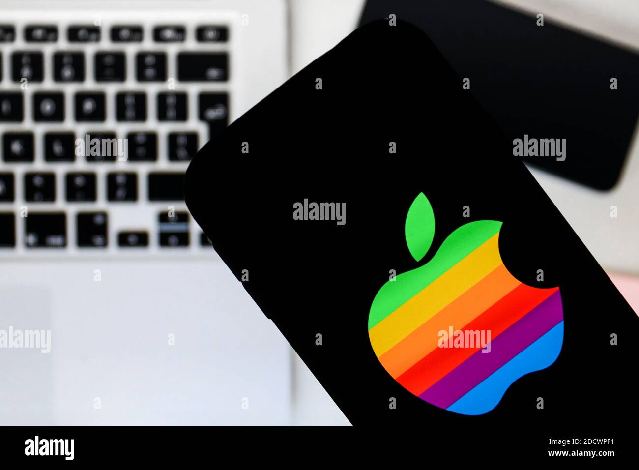 In this photo illustration an Apple company logo seen displayed on a ...