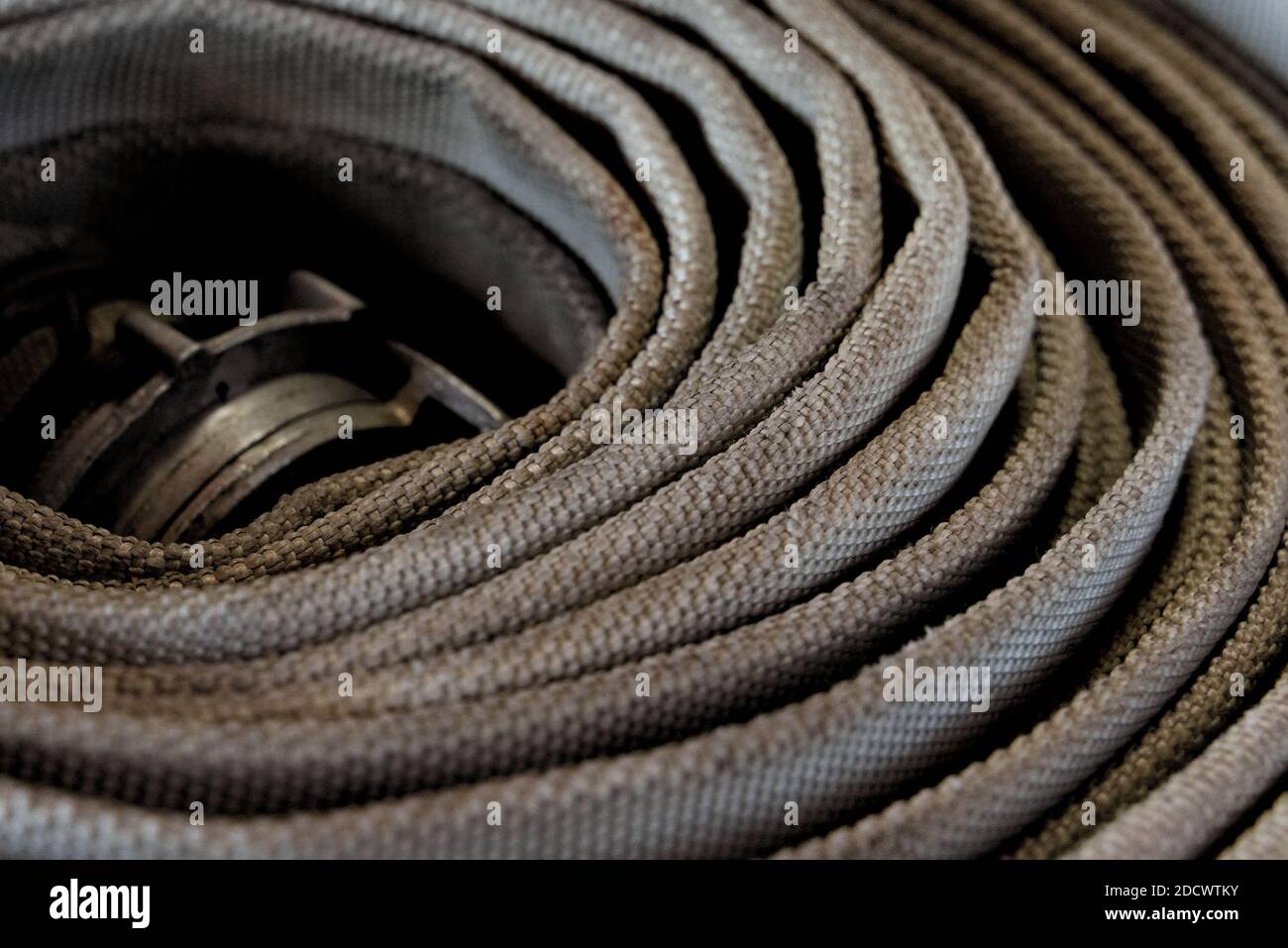 Fire fighter hose rolled up and ready for action. Close-up Stock Photo ...