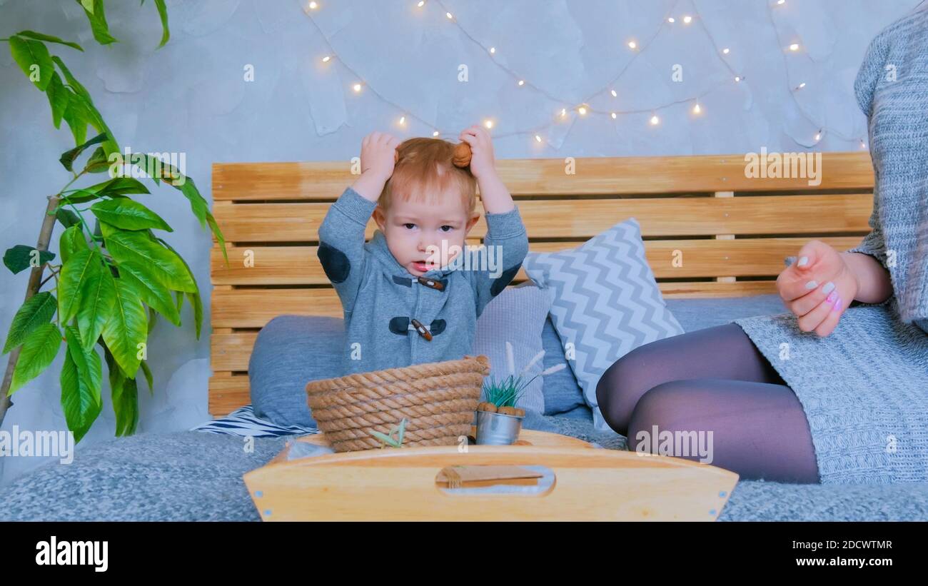 Happy young mother and her baby son playing with walnuts Stock Photo ...