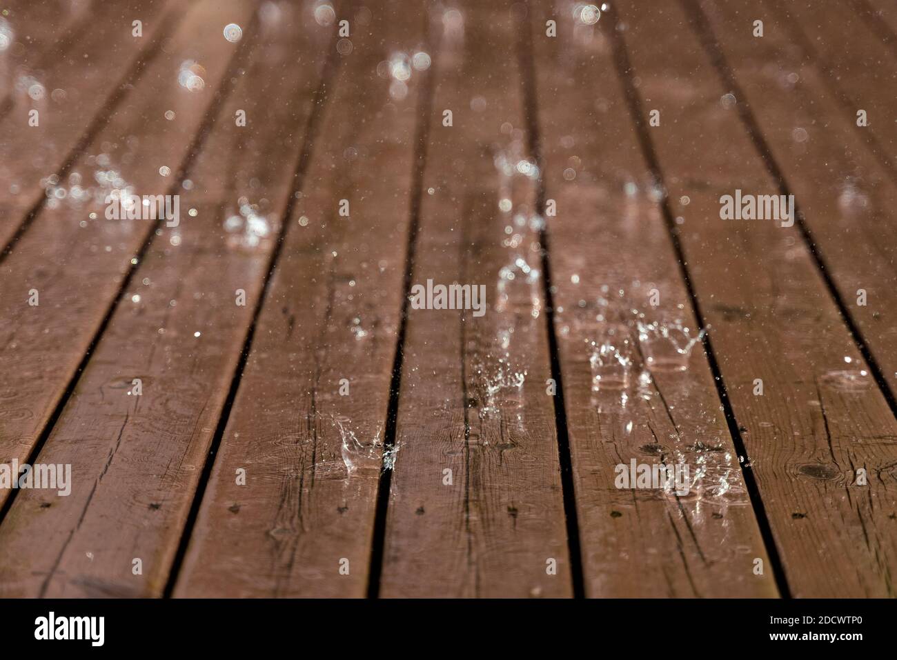 Rain from thunderstorm splash down on old worn wooden floor Stock Photo ...