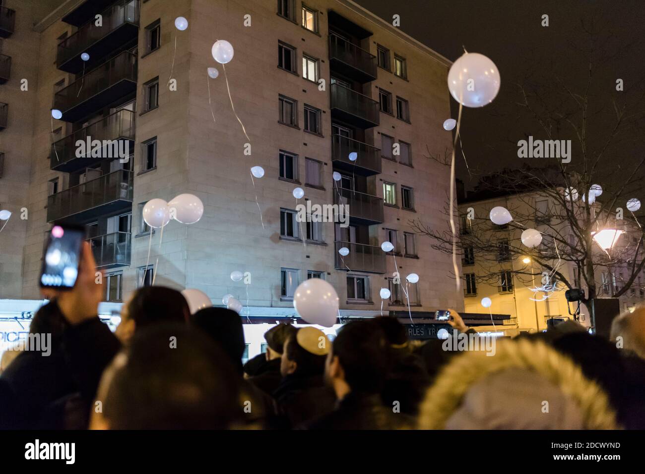 Dozens of people gathered in front of the Hyper Cacher store in the ...