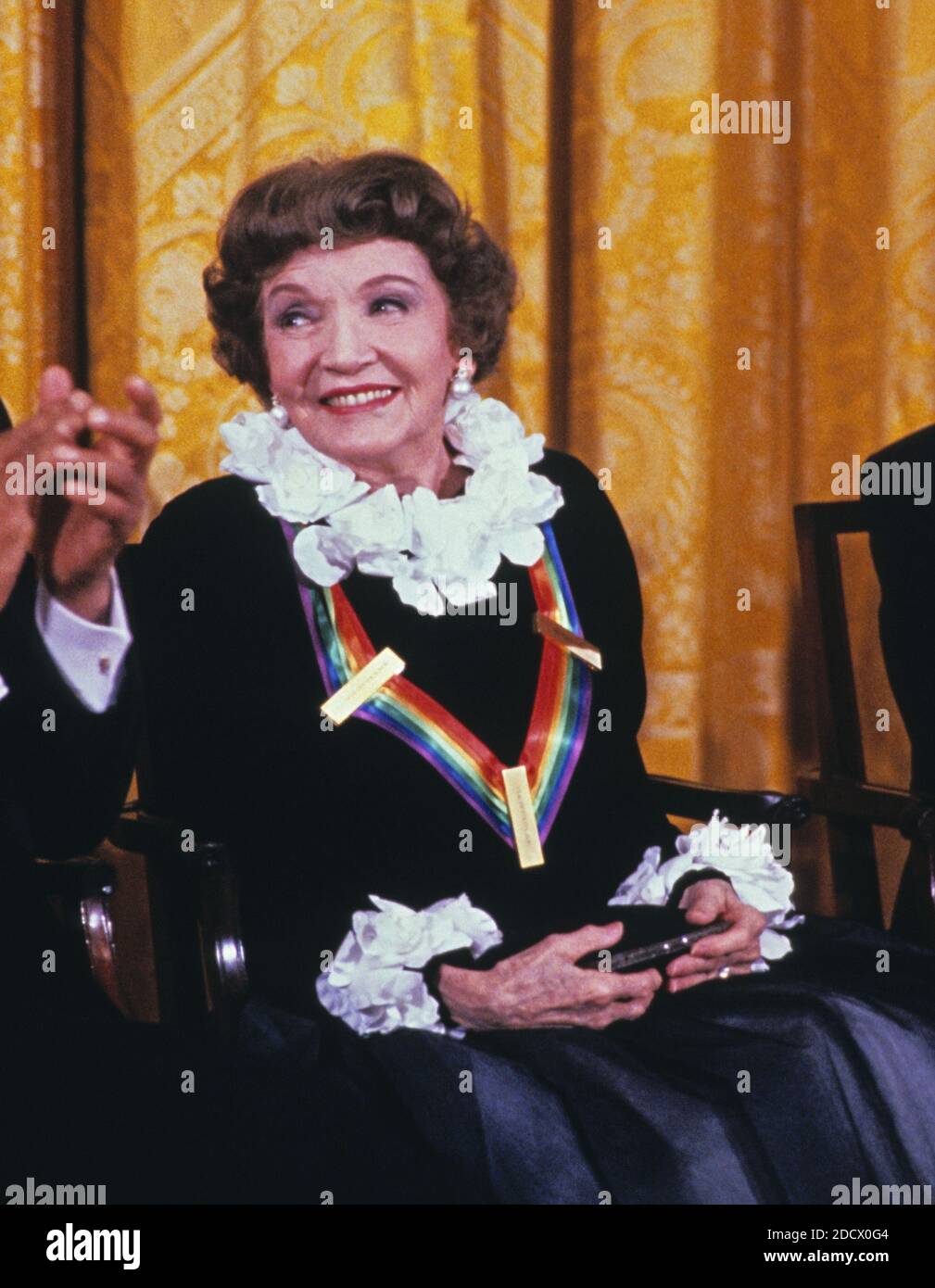 Actress Claudette Colbert listens as first lady Barbara Bush makes ...