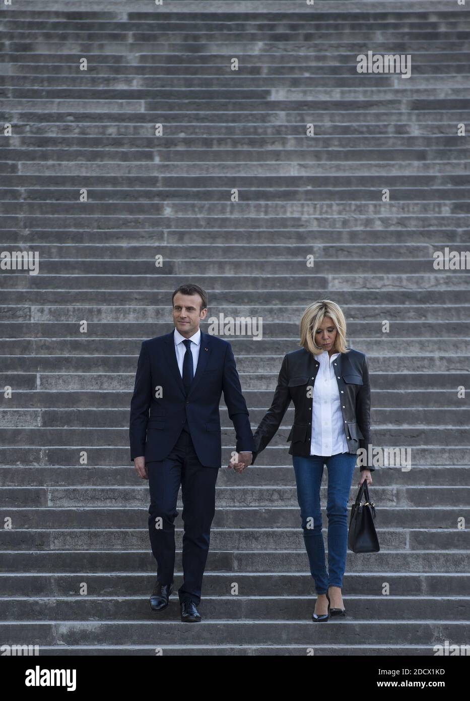 French President Emmanuel Macron and first lady Brigitte Macron walk ...