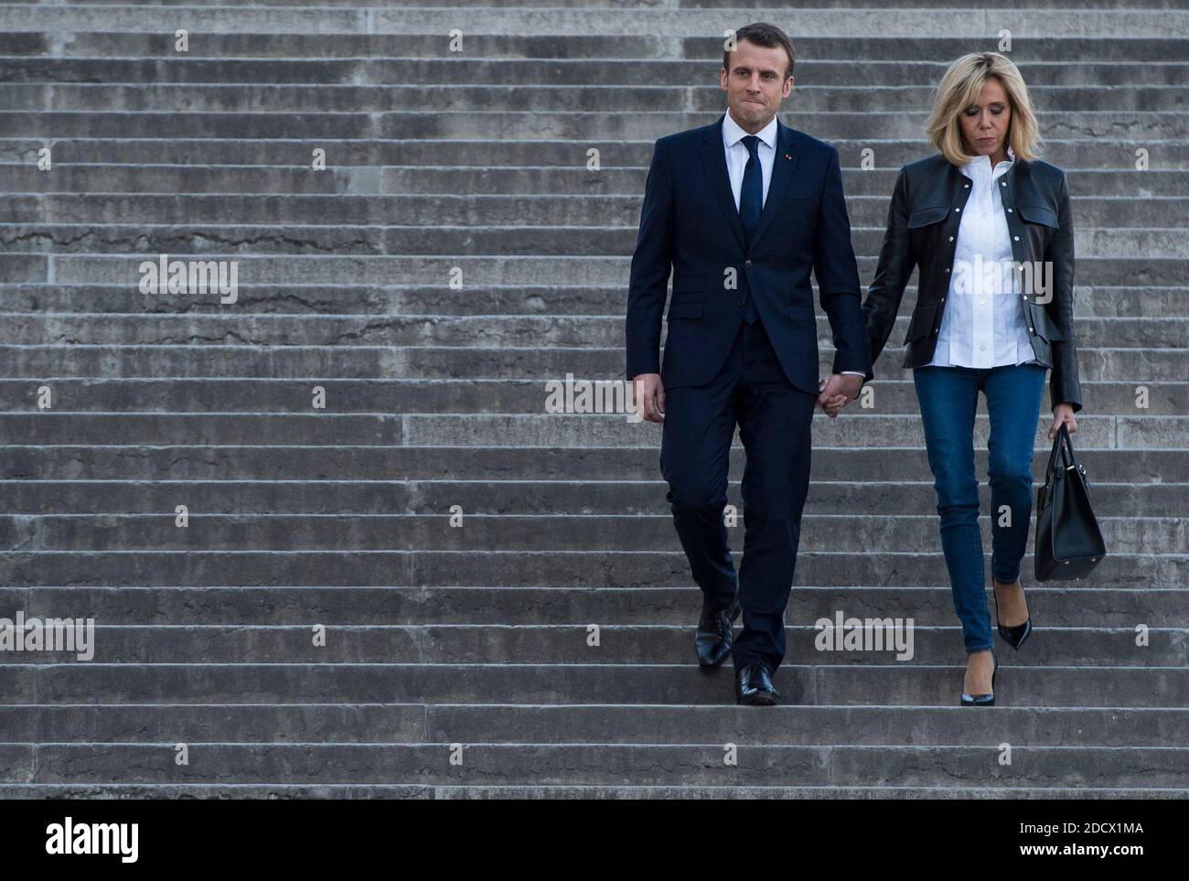 French President Emmanuel Macron and first lady Brigitte Macron walk ...