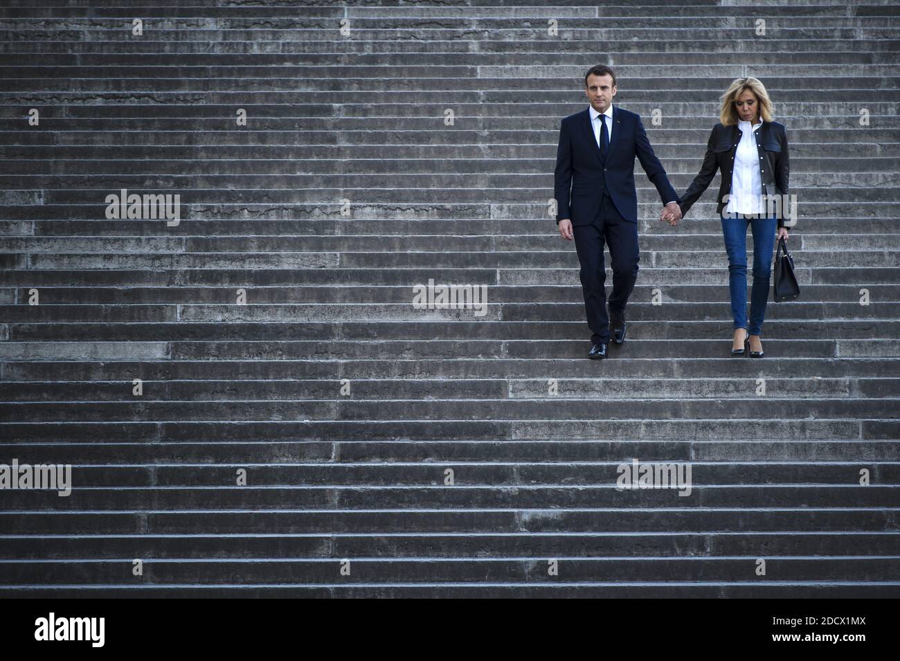 French President Emmanuel Macron and first lady Brigitte Macron walk ...