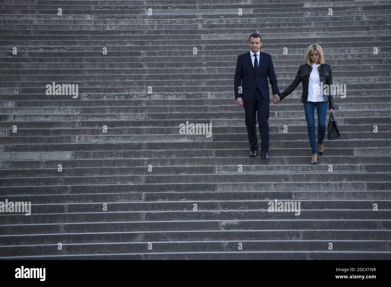 French President Emmanuel Macron and first lady Brigitte Macron walk ...
