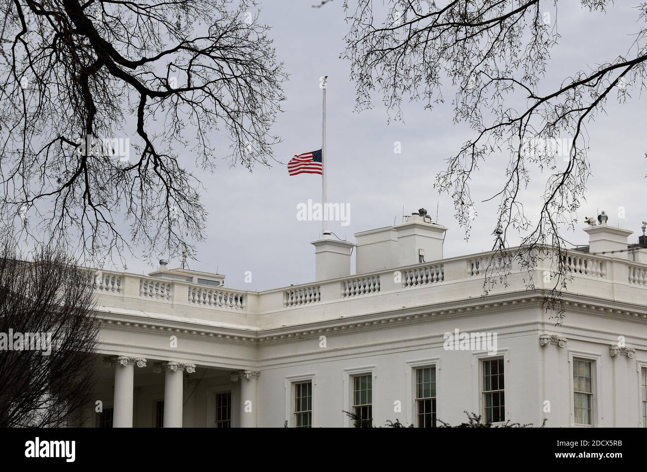The American flag above the White House is lowered to half staff following the shooting ...