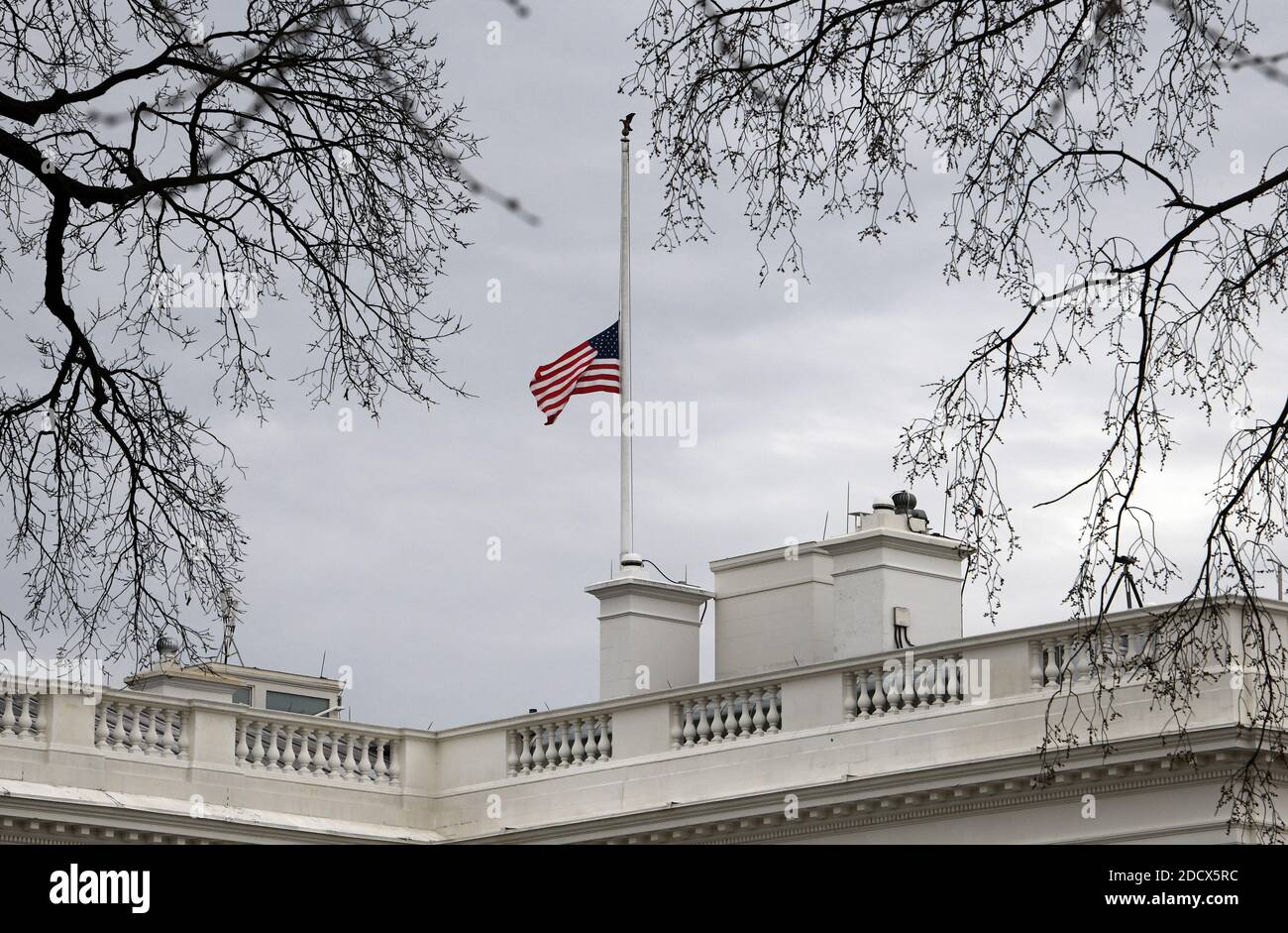 The American flag above the White House is lowered to half staff following the shooting ...