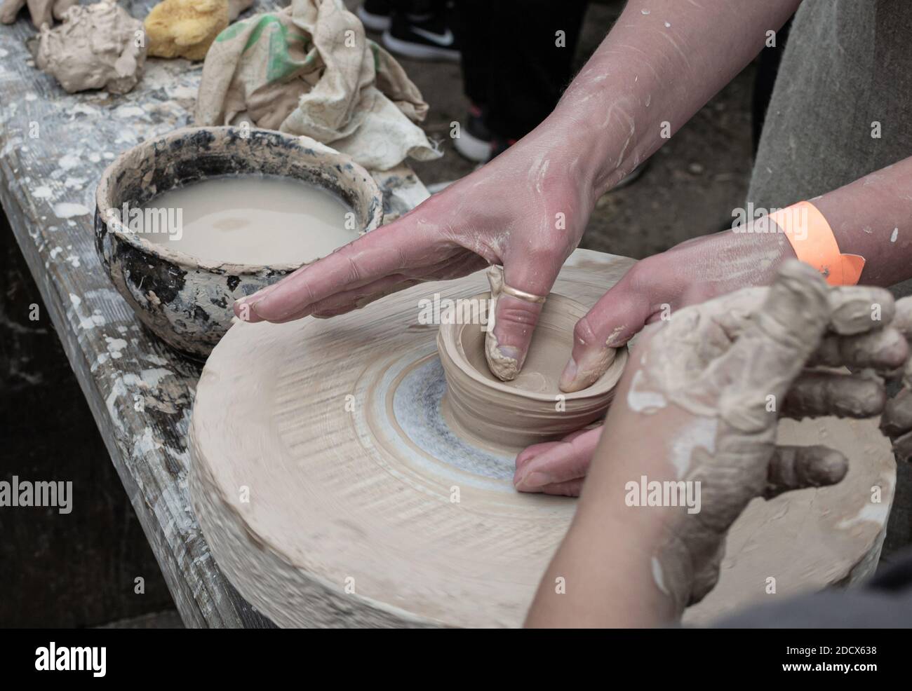 Clay modeling training on a potters wheel in the open air. Art ...