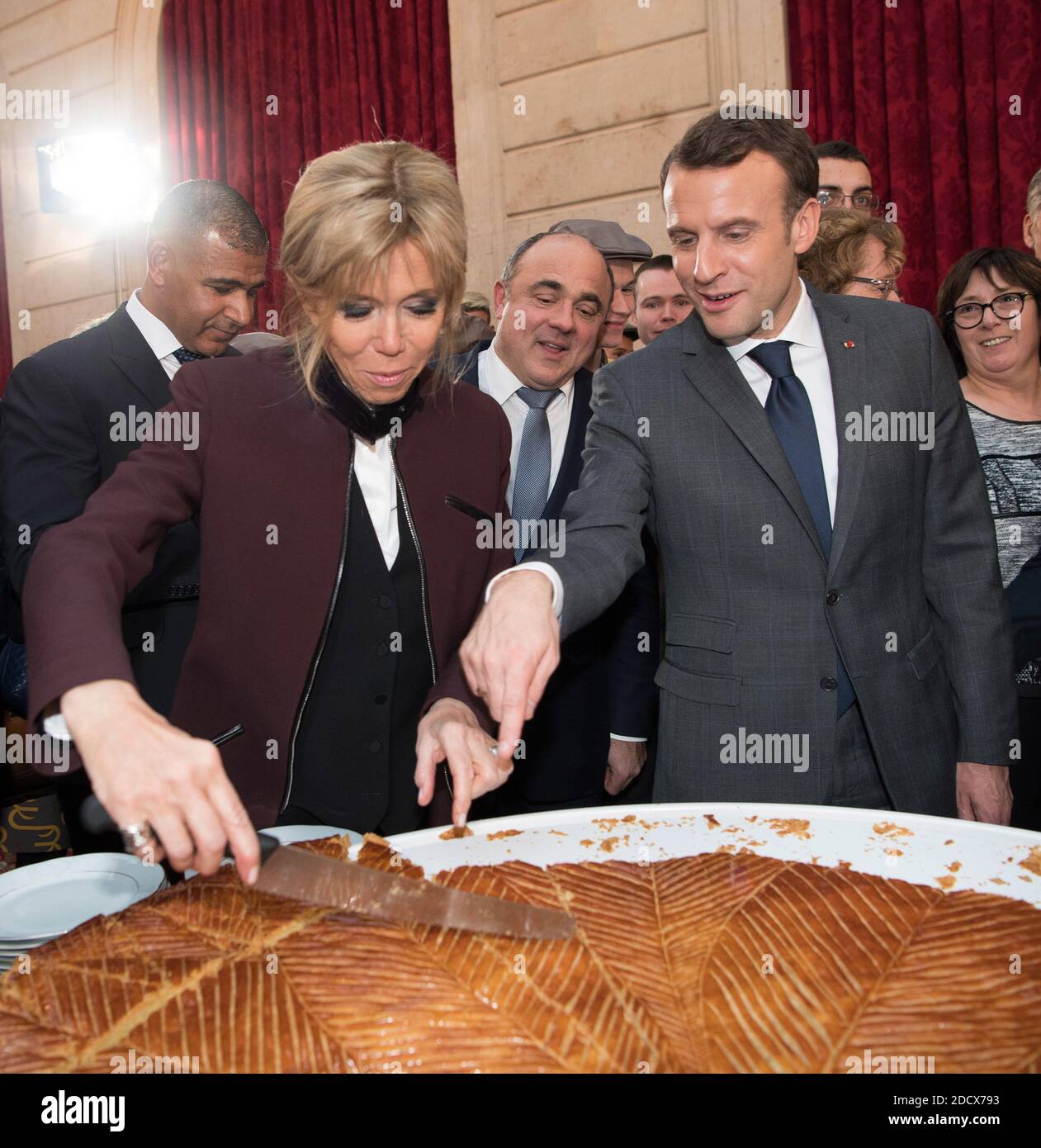 French President Emmanuel Macron and his wife Brigitte Macron cut ...