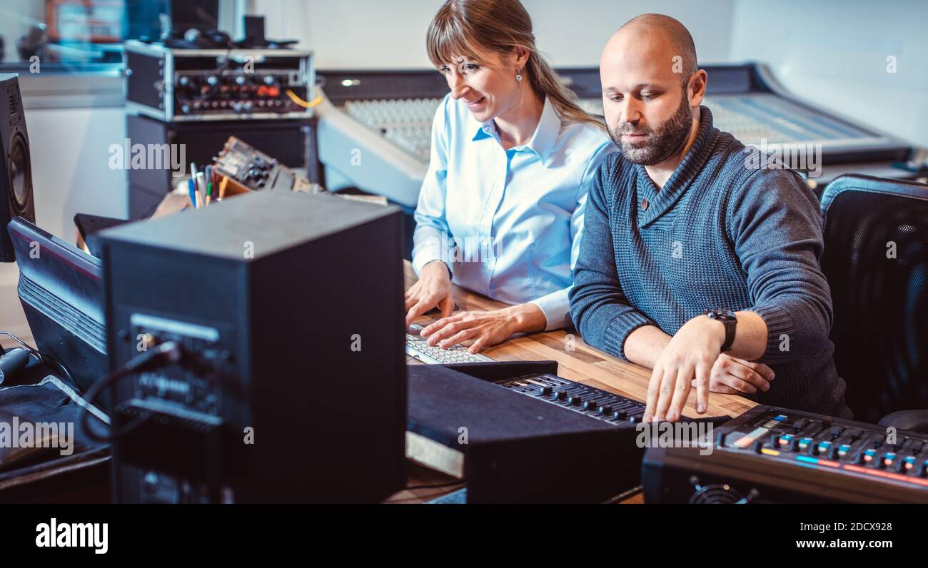 Singer or artist and sound engineer working in the studio Stock Photo ...