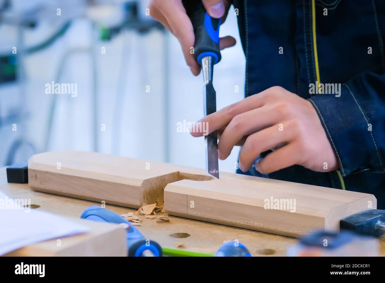 Carpenter using chisel to carve wood Stock Photo - Alamy