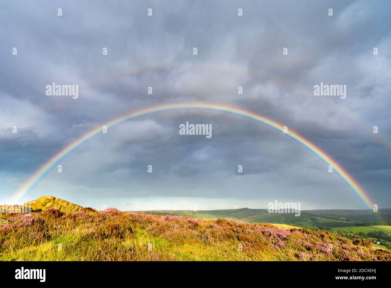 Stunning full rainbow with dramatic storm clouds in the English Peak ...