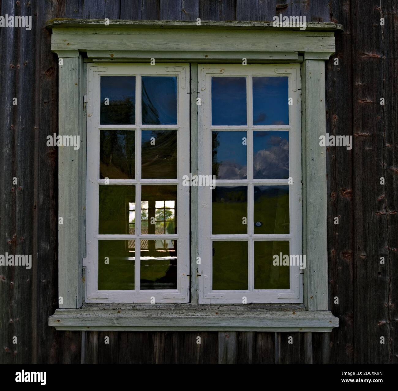 Classical old window with white window frame and brown varnished wooden ...