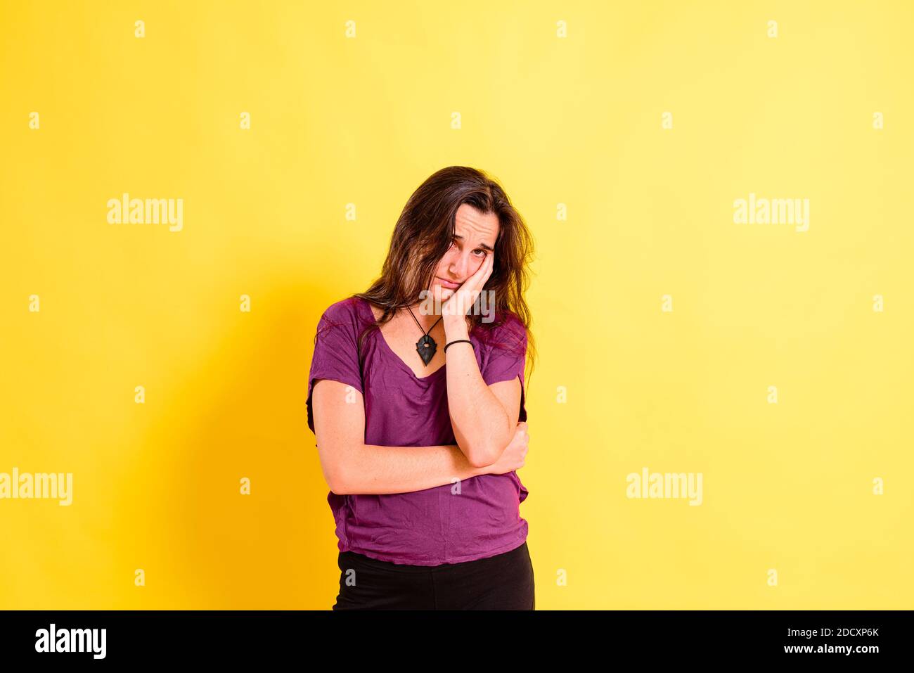 young woman with toothache and hand gesture resting on cheek, isolated ...
