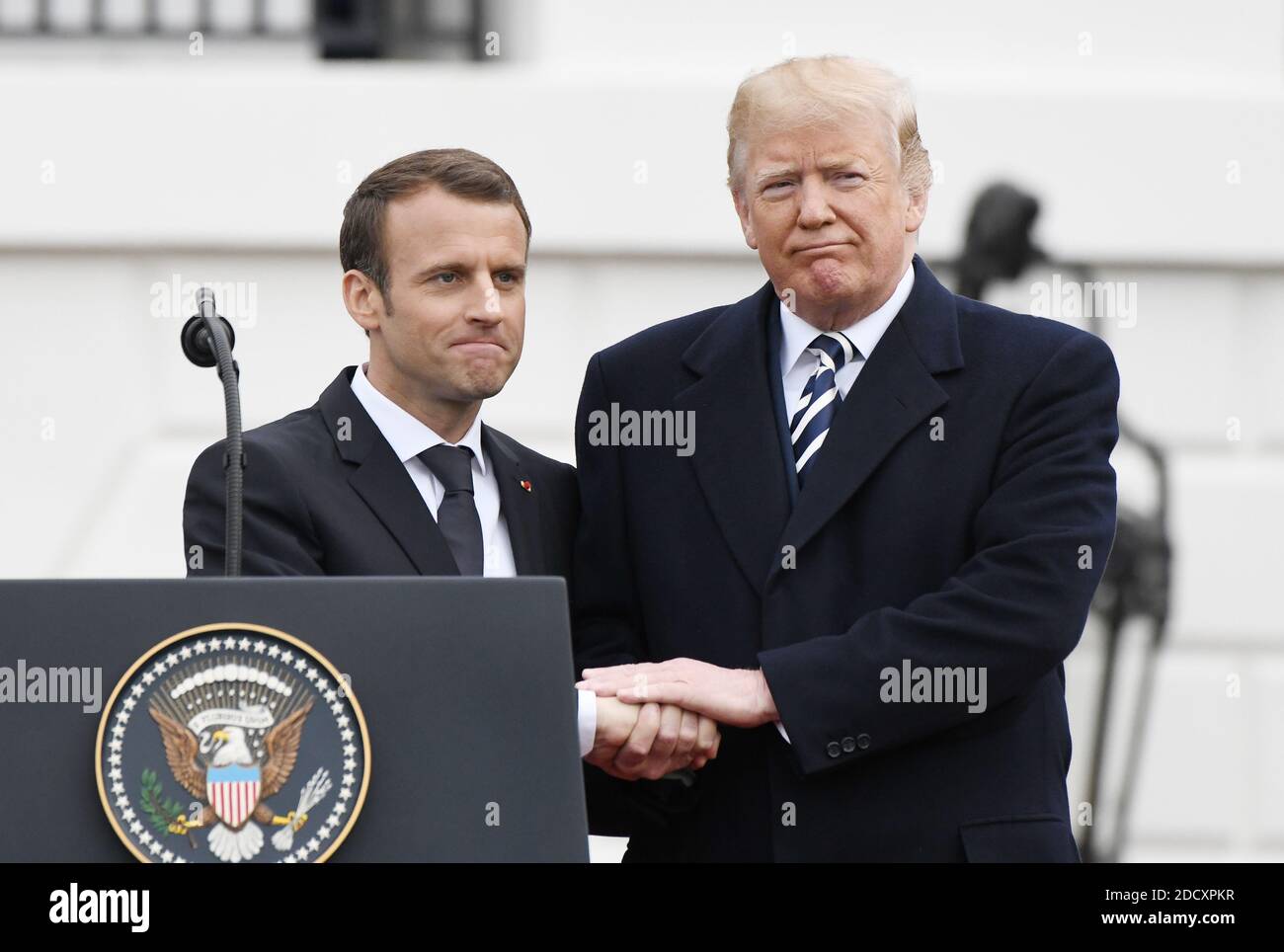French President Emmanuel Macron hugs with US President Donald Trump ...