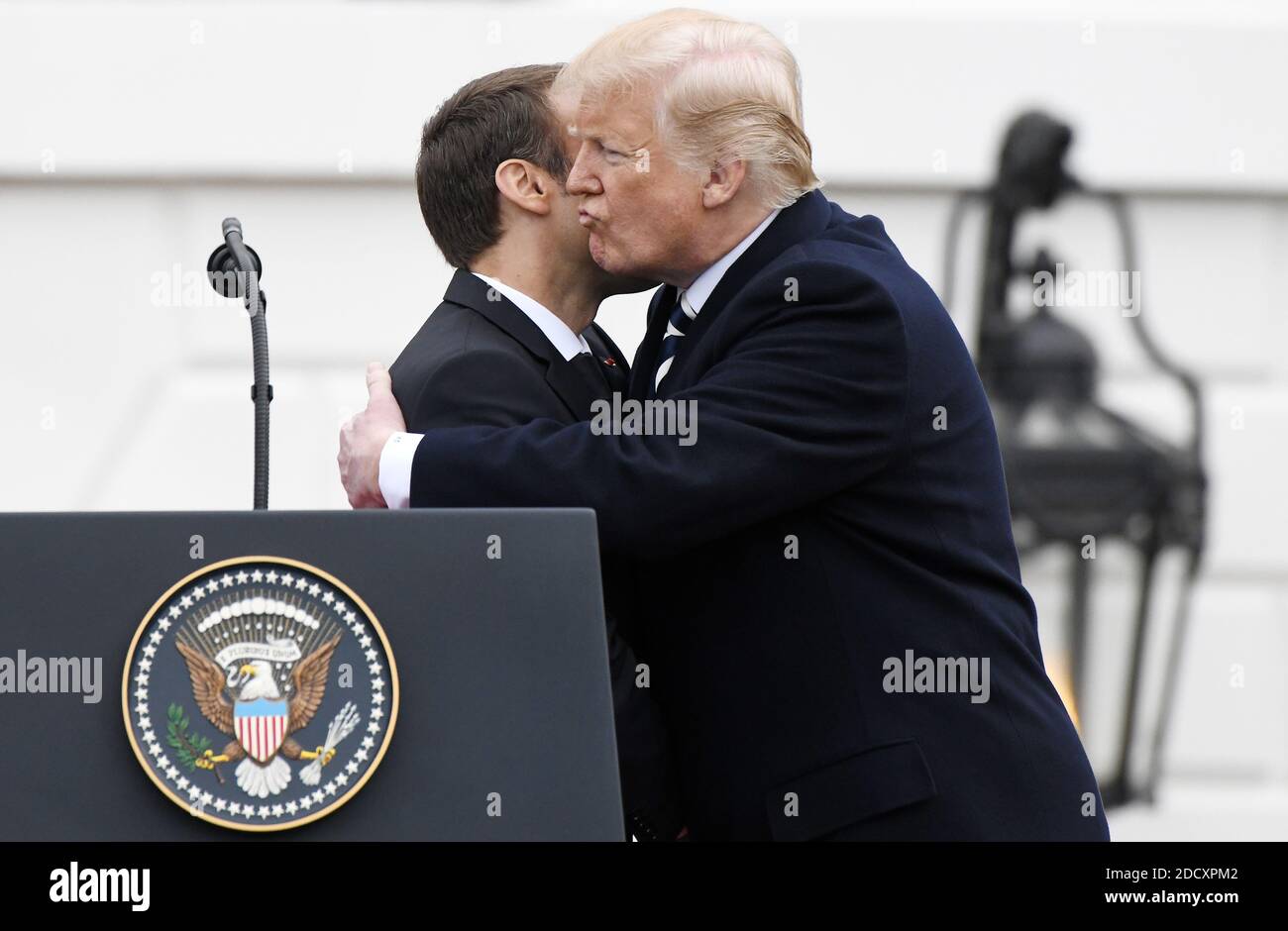 French President Emmanuel Macron hugs with US President Donald Trump ...
