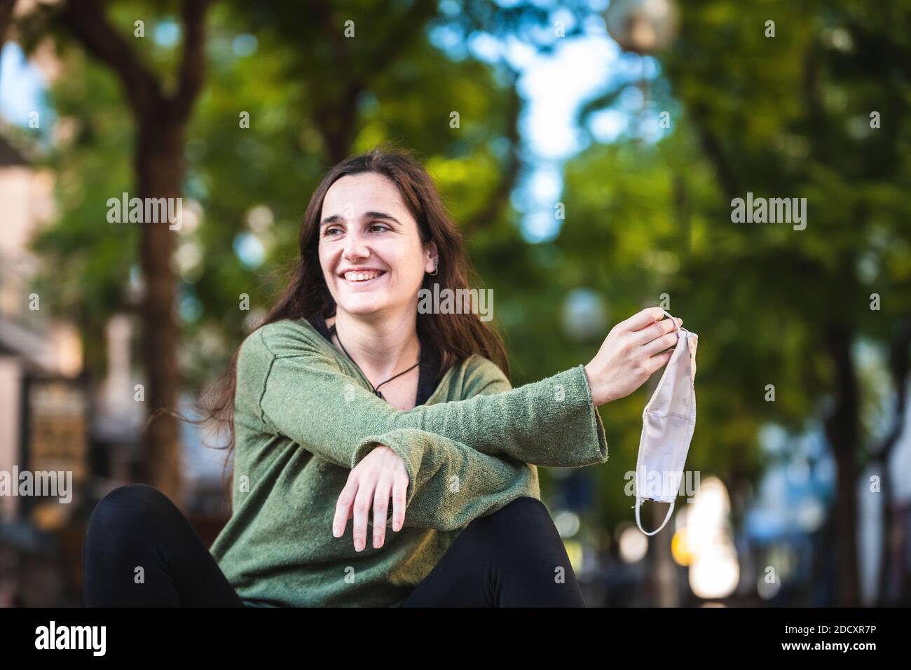 Young woman removes mask from her face with relief before the end of ...