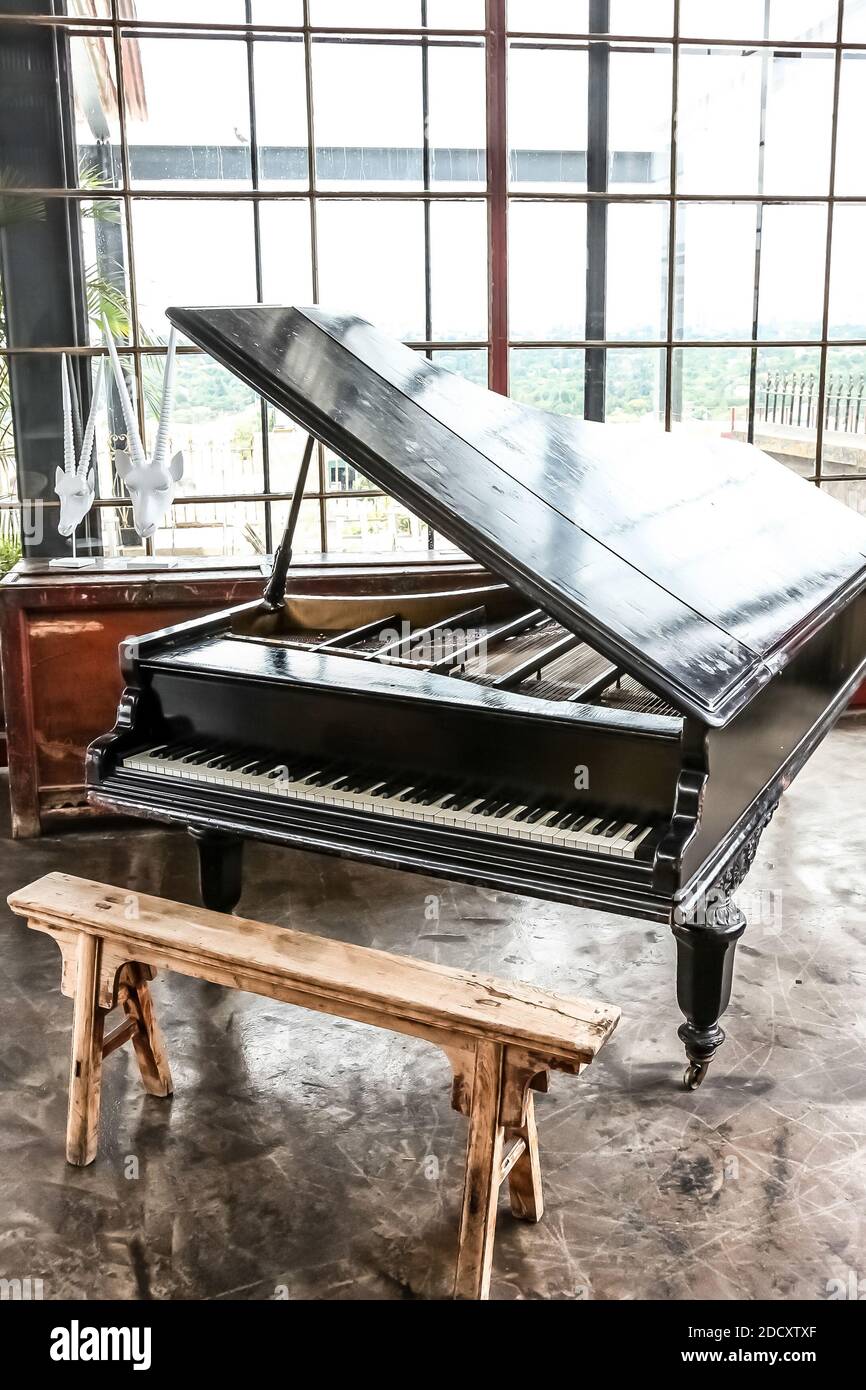 A vertical shot of an opened grand piano inside a vintage interior ...