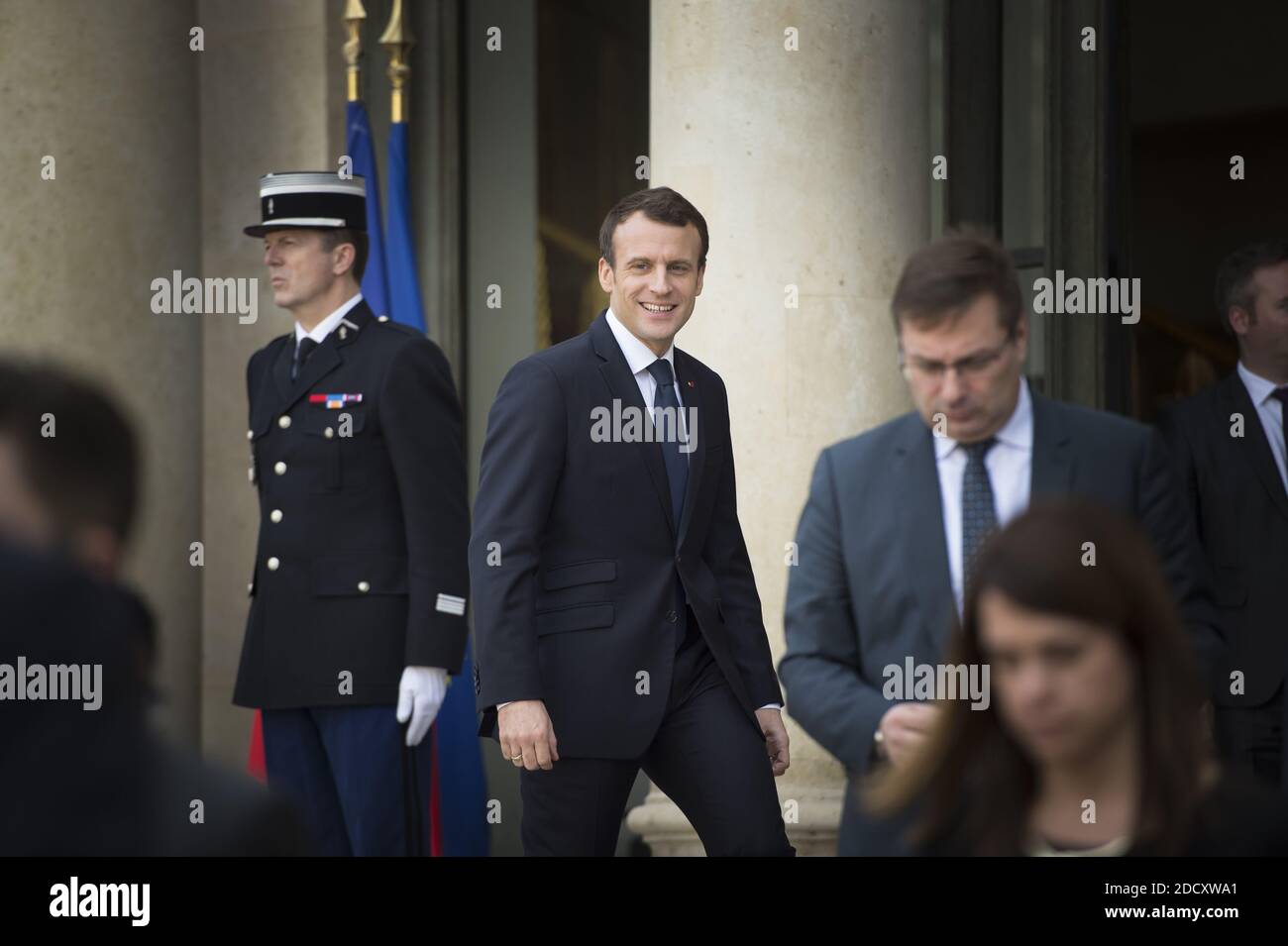 French President Emmanuel Macron smiles and gestures at Elysee Palace ...