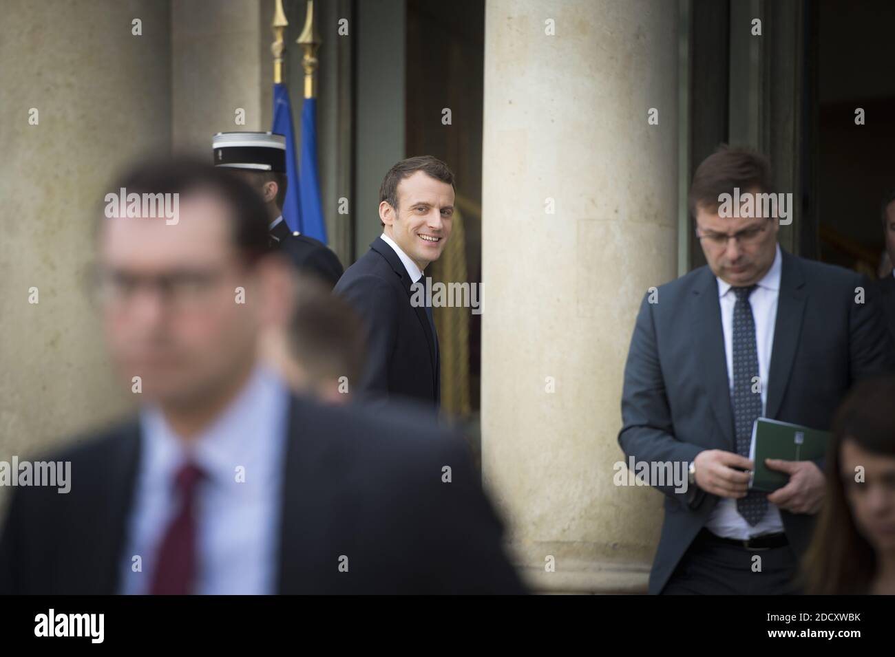 French President Emmanuel Macron smiles and gestures at Elysee Palace ...