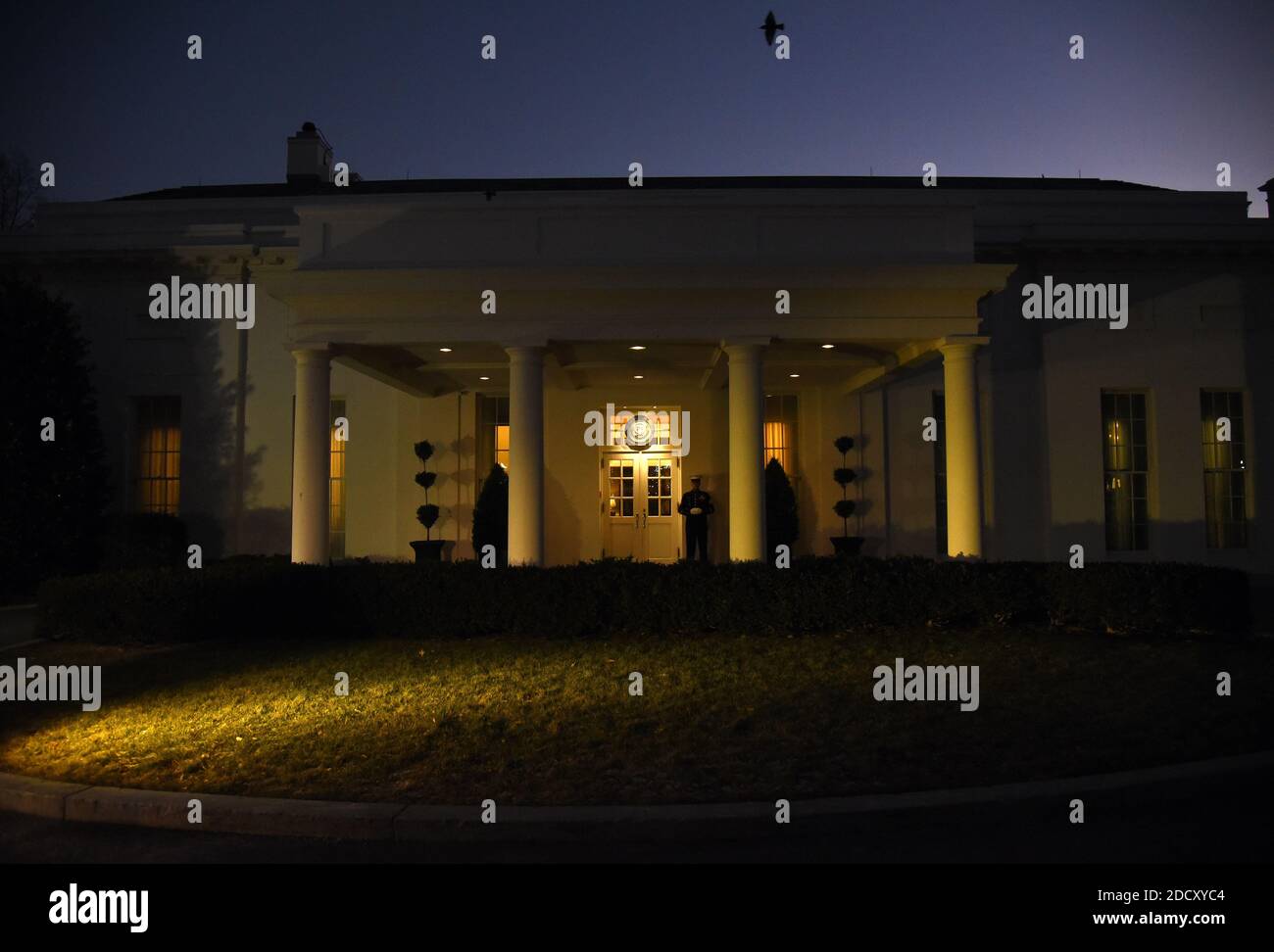 A Marine stands still at the West Wing entrance of the White House as ...