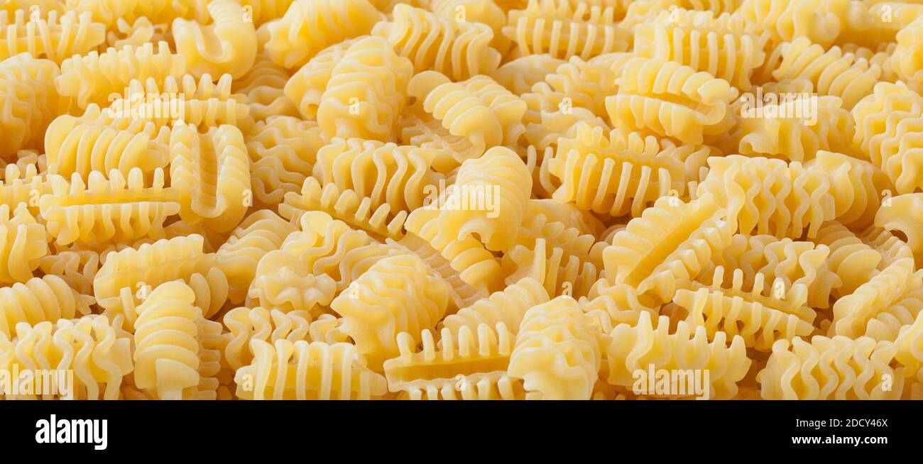 Uncooked radiatori pasta background Stock Photo - Alamy