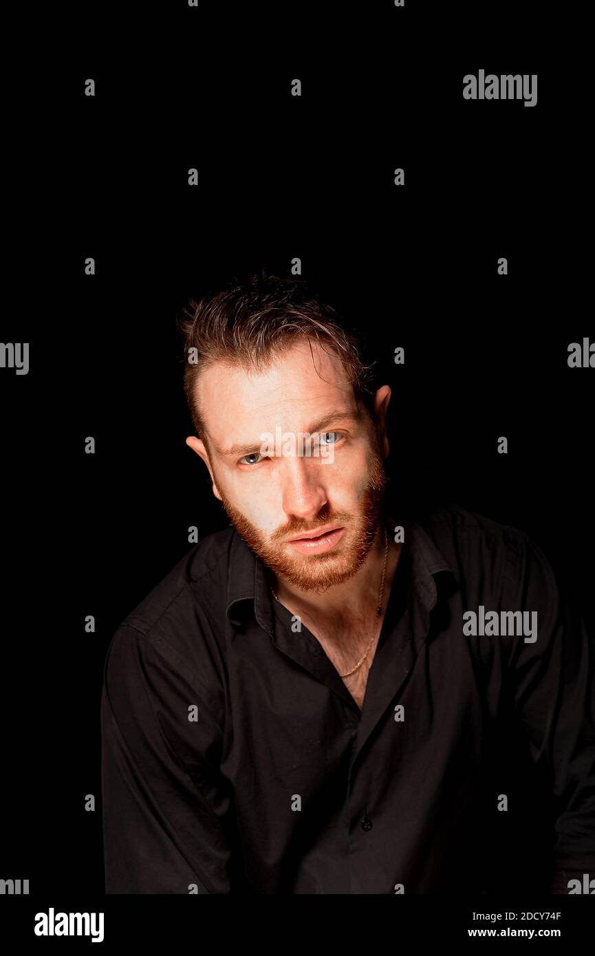 A man on a black background .Aggressive facial expression. Criminal ...