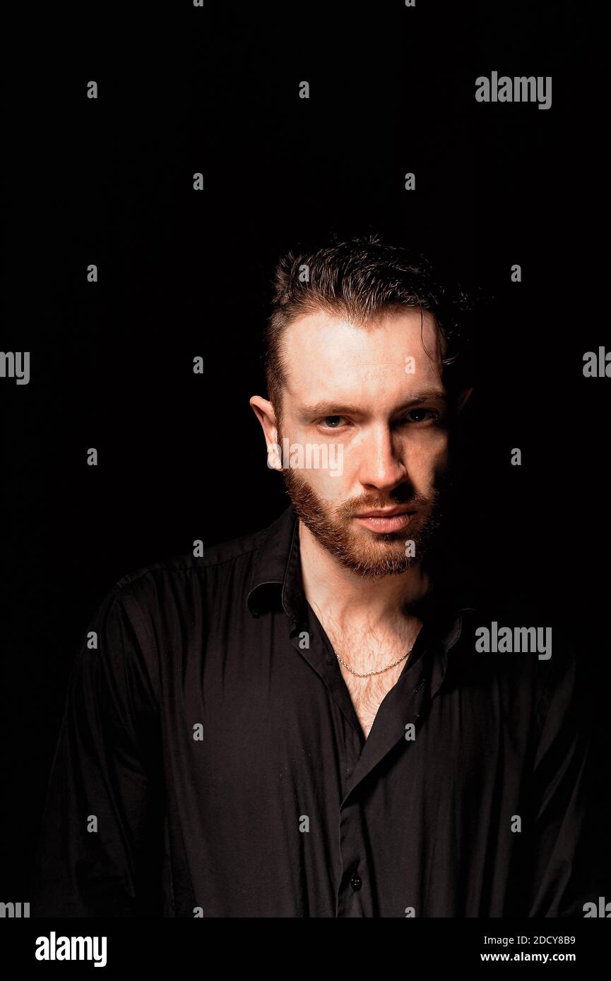 A man on a black background .Aggressive facial expression. Criminal ...
