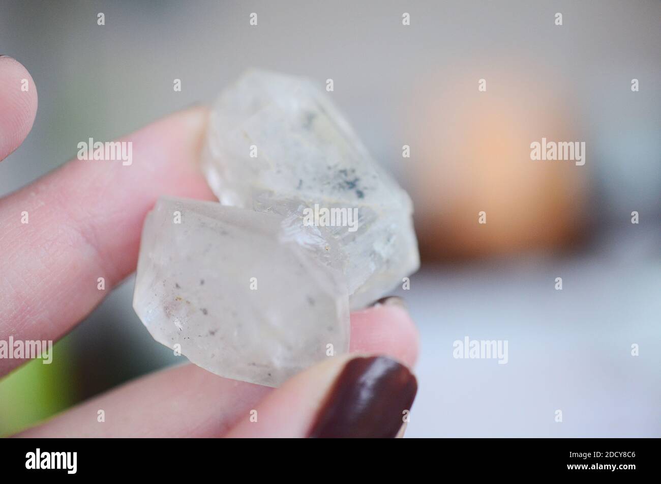 Clear quartz being held in woman's hand. Clear quartz point in the ...
