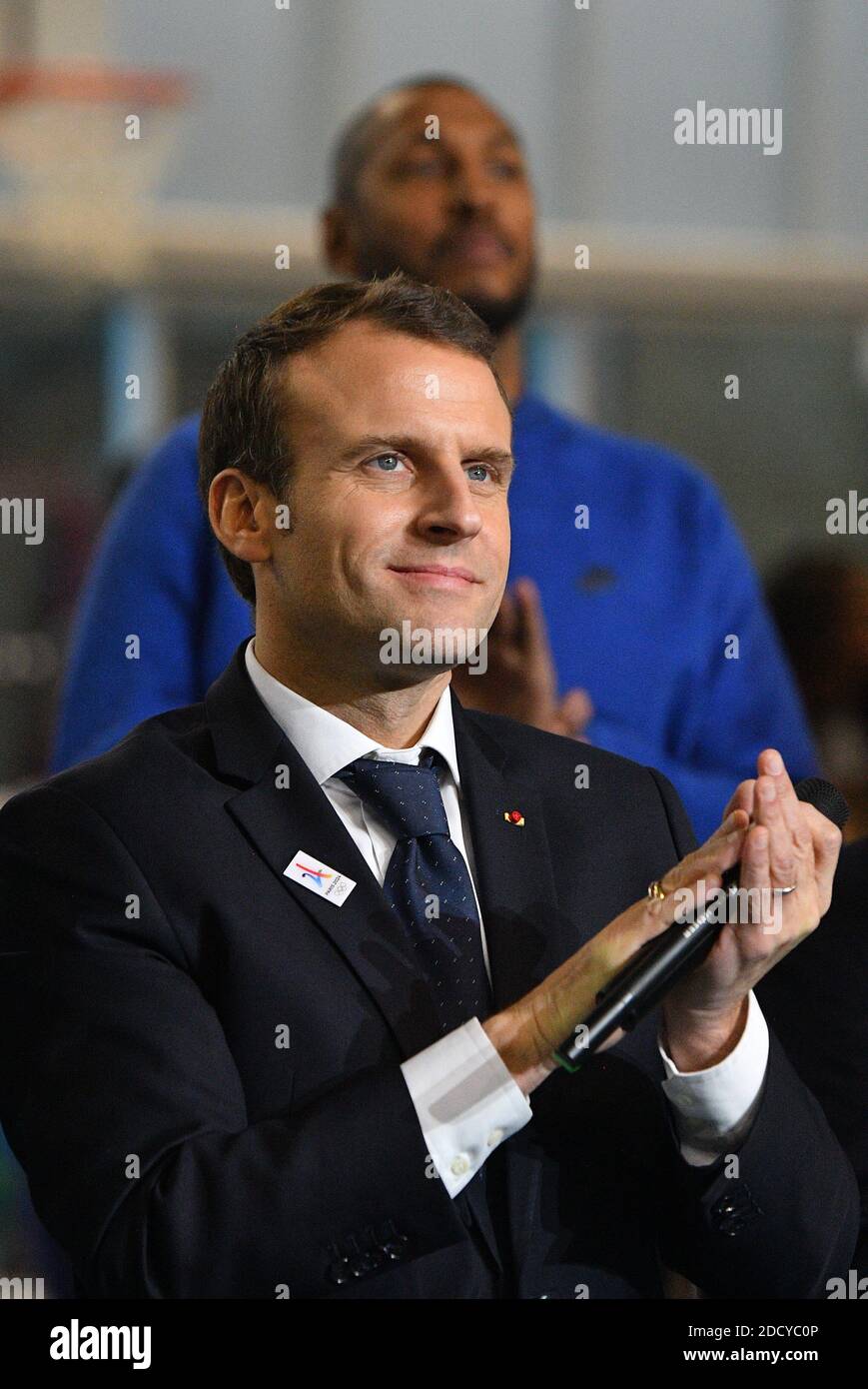 French President Emmanuel Macron watches children practise basketball ...