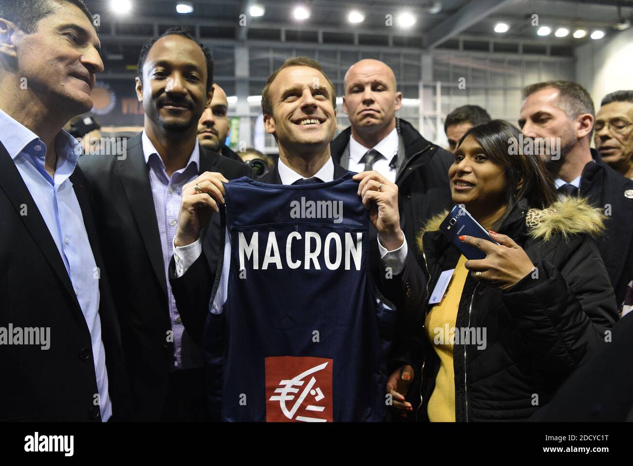 French President Emmanuel Macron watches children practise basketball ...