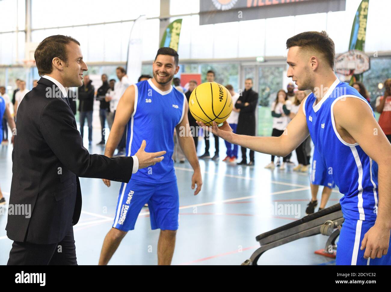 French President Emmanuel Macron watches children practise basketball ...