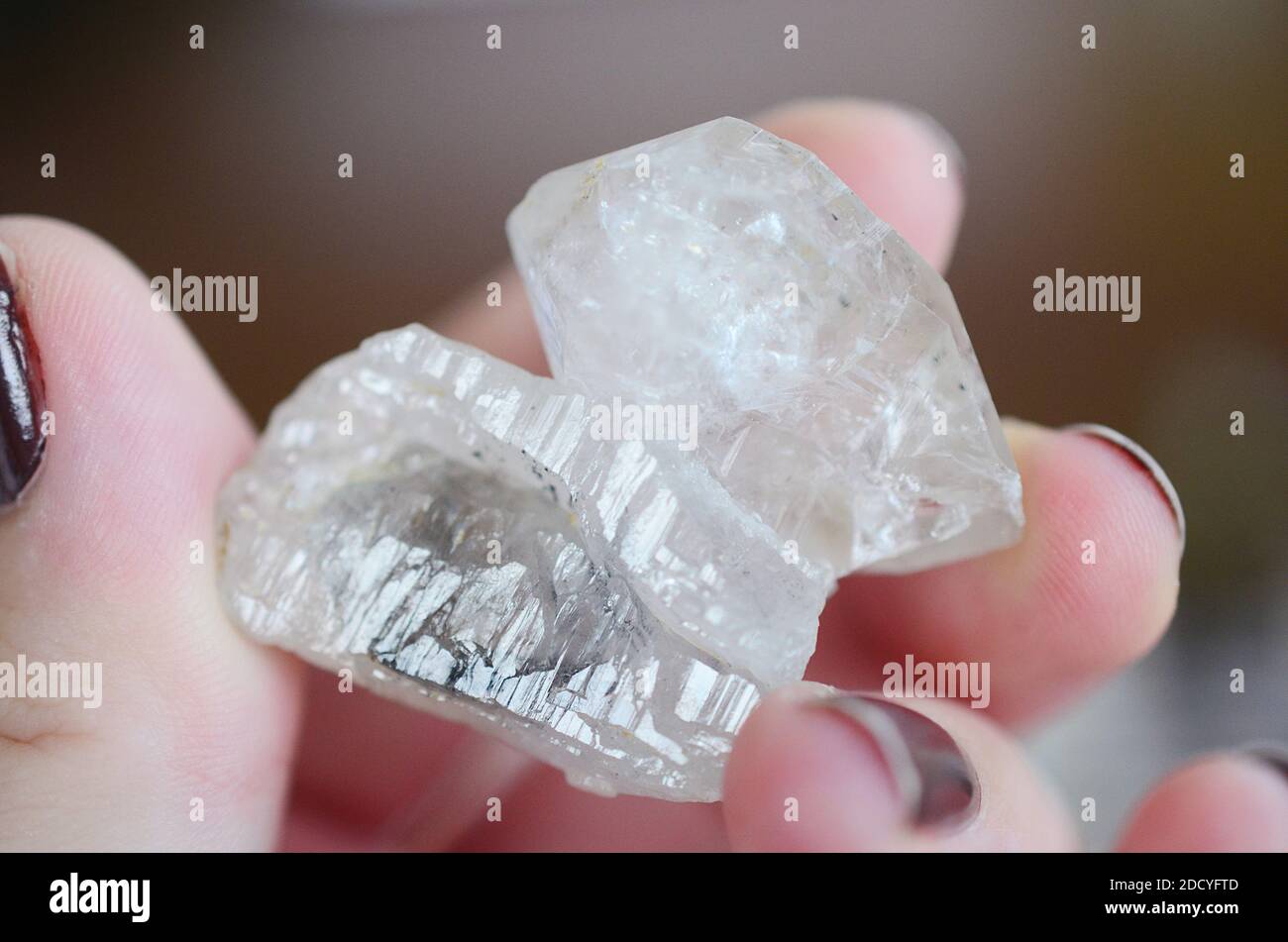 Clear quartz being held in woman's hand. Clear quartz point in the ...