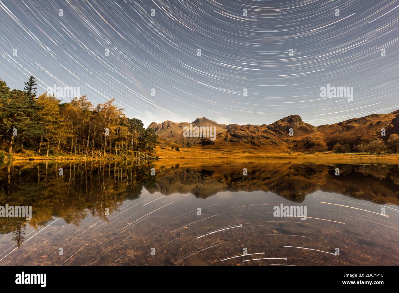 Star trail reflections in a calm lake. Taken at Blea Tarn in the ...