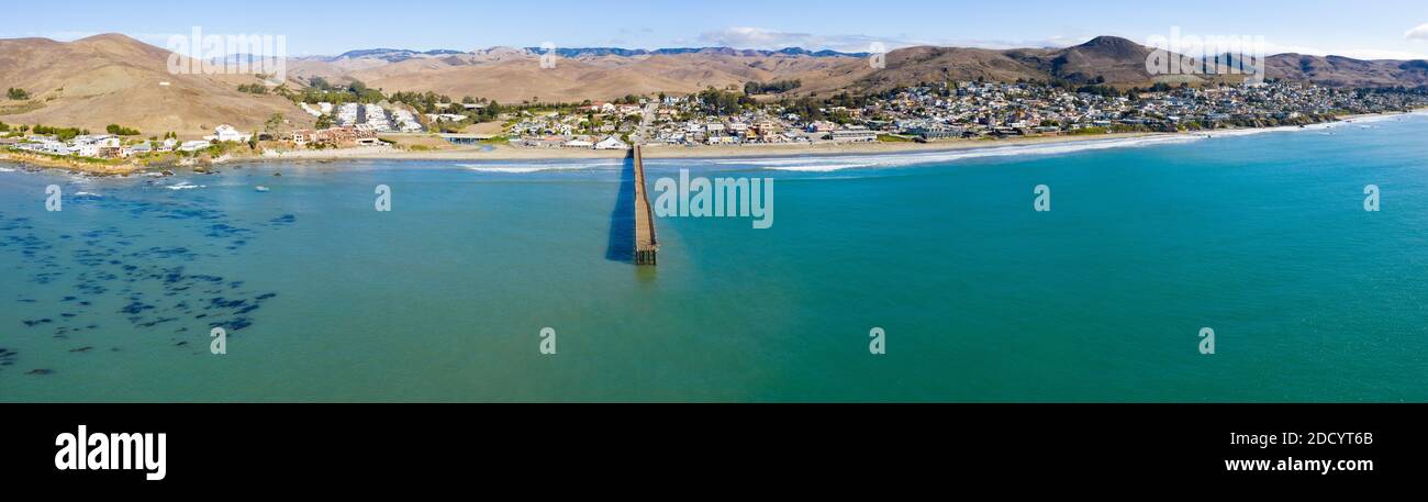 A long pier reaches out into the Pacific Coast in the quaint city of ...